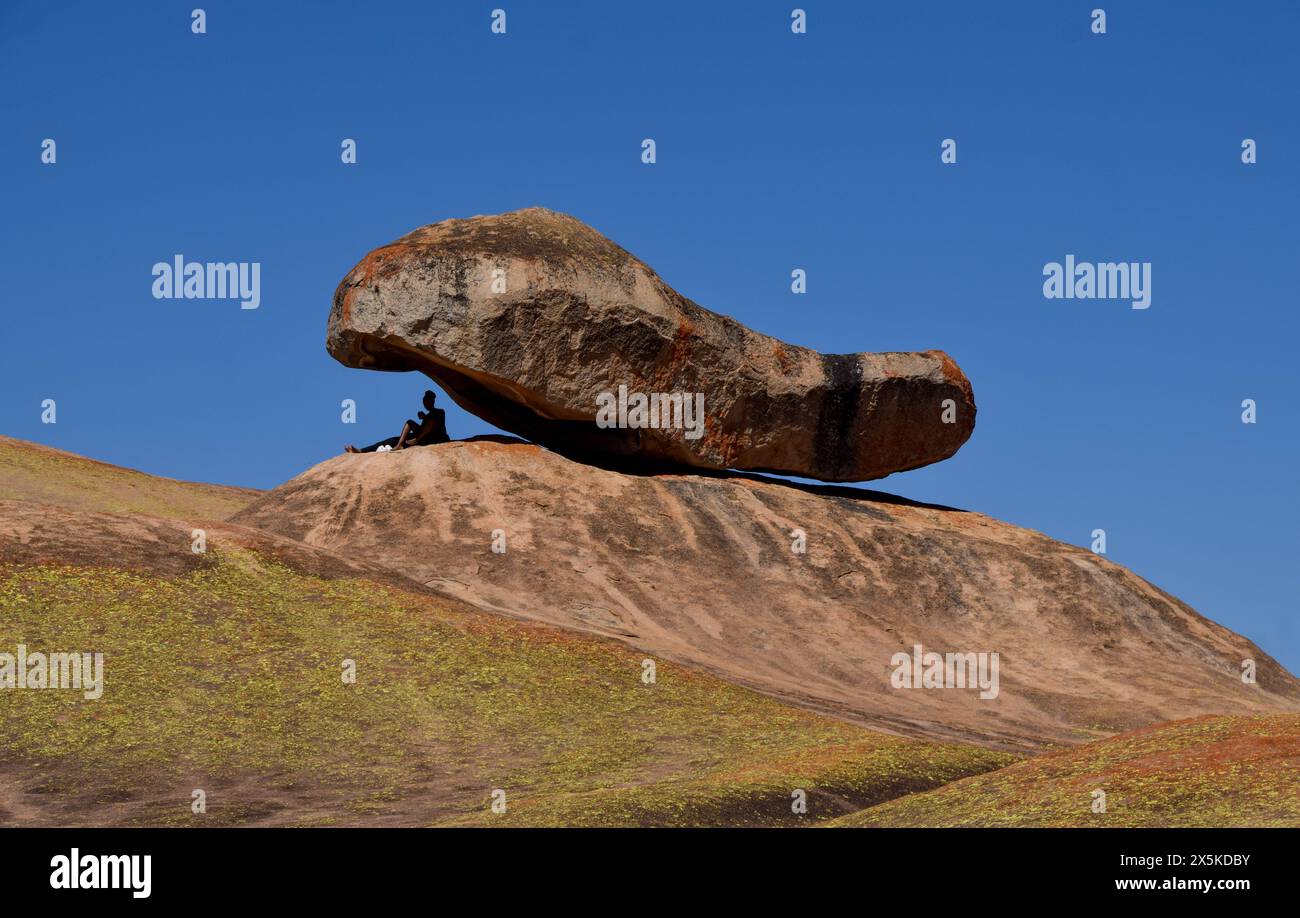 Zimbabwe. 1st May 2024. People sit in the shade under the balancing ...