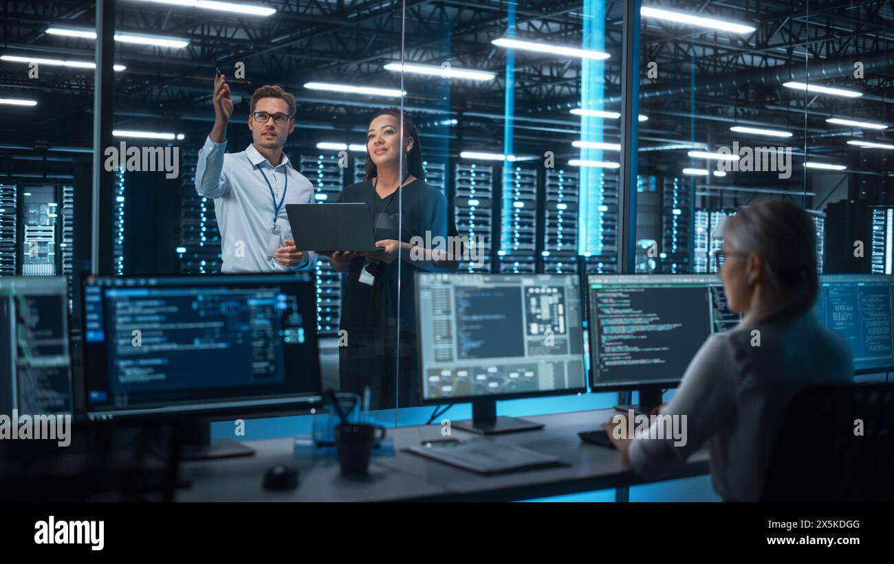 Multiethnic Female System Administrator and Caucasian Male Information Technology Engineer ...