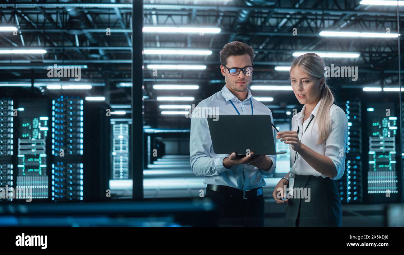 Programmers talk standing laptop hi-res stock photography and images ...