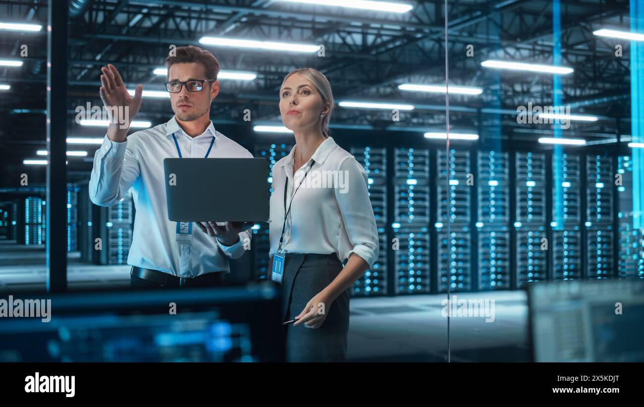 In Data Center: Male and Female Business Partners Talk, Look Away and ...