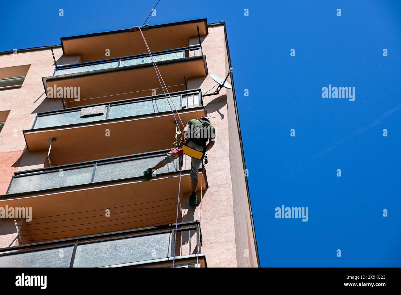 high-rise work on an apartment building. A construction worker inspects ...