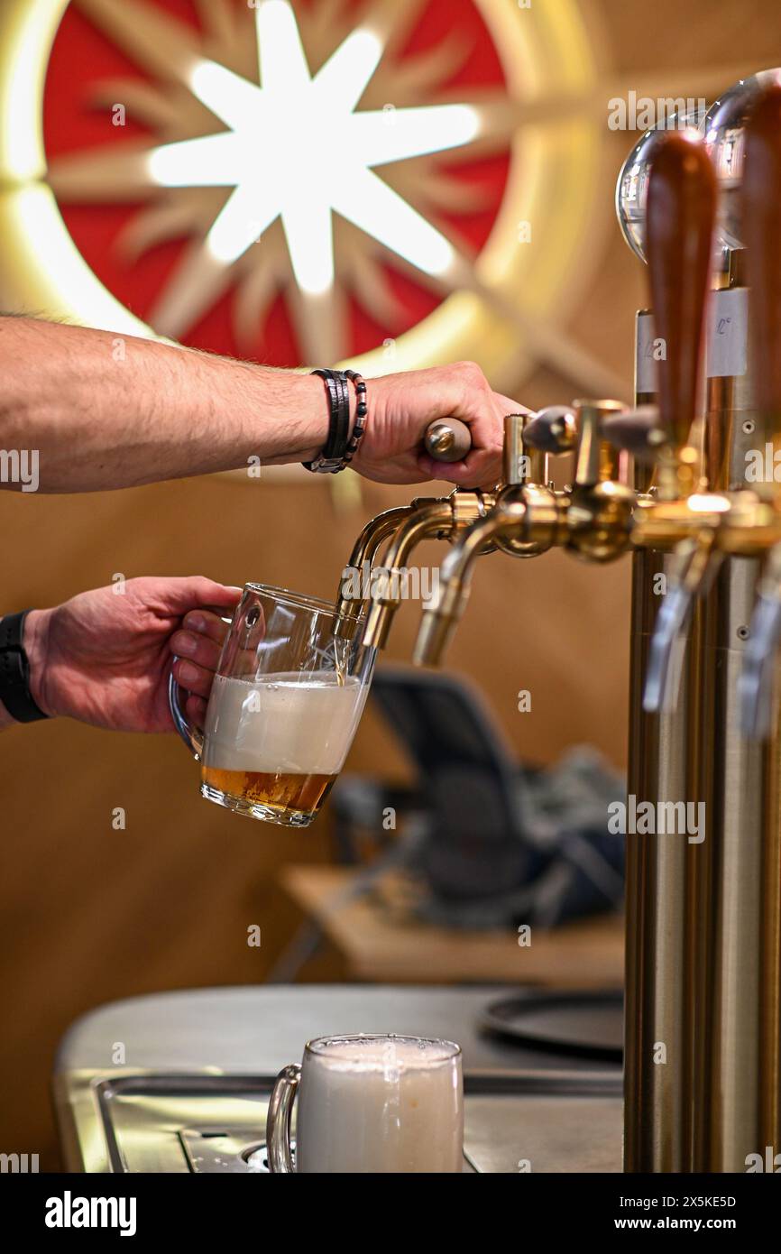 the waiter is capping a beer at the bar Stock Photo - Alamy
