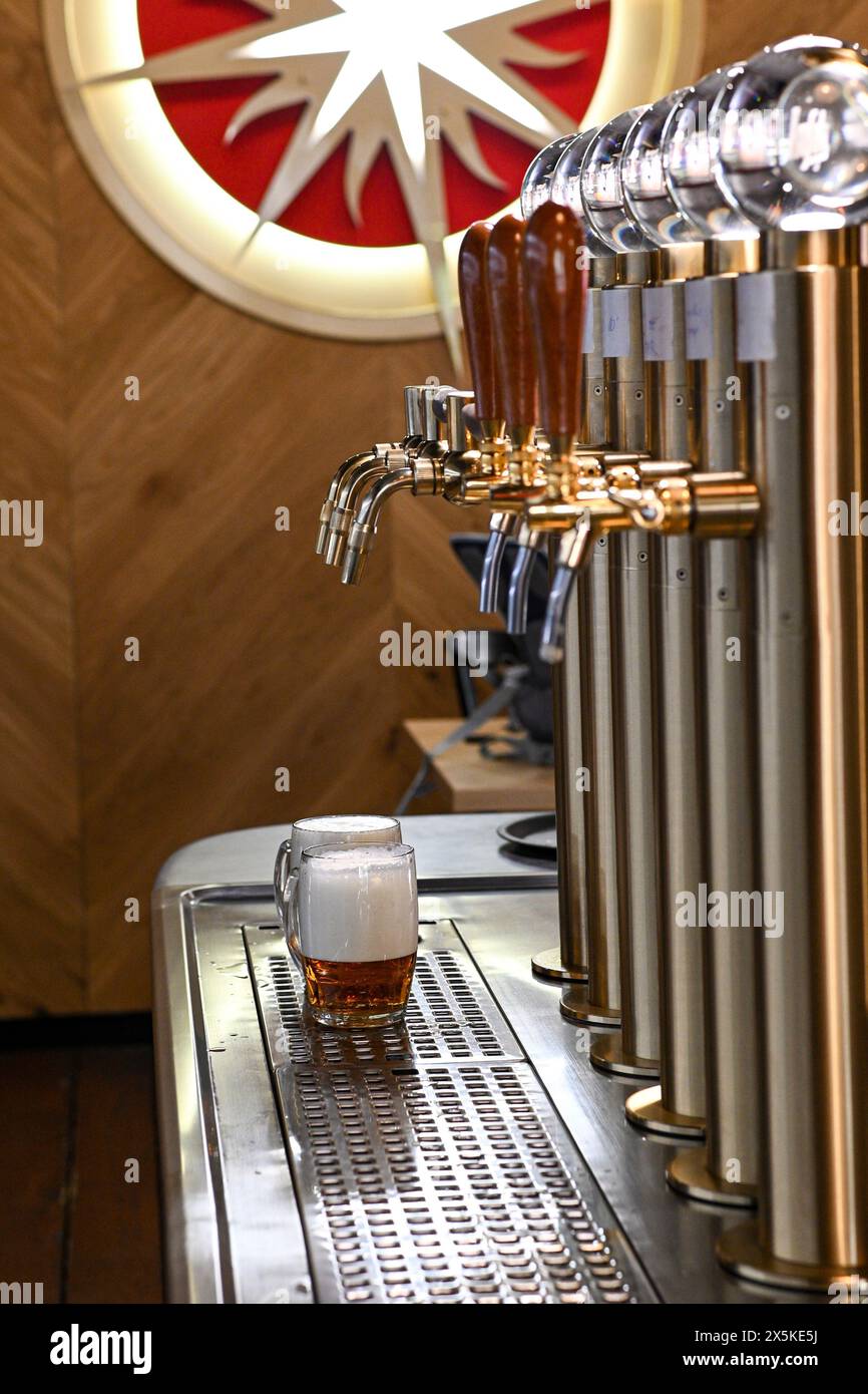 the waiter is capping a beer at the bar Stock Photo - Alamy