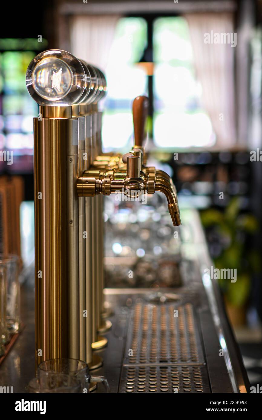 the waiter is capping a beer at the bar Stock Photo - Alamy