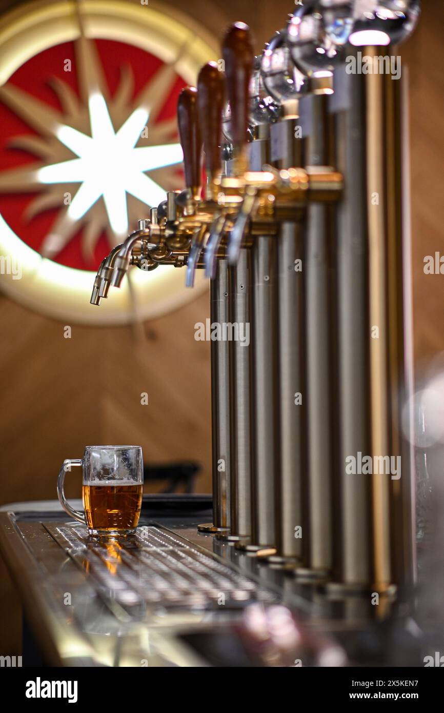 the waiter is capping a beer at the bar Stock Photo - Alamy