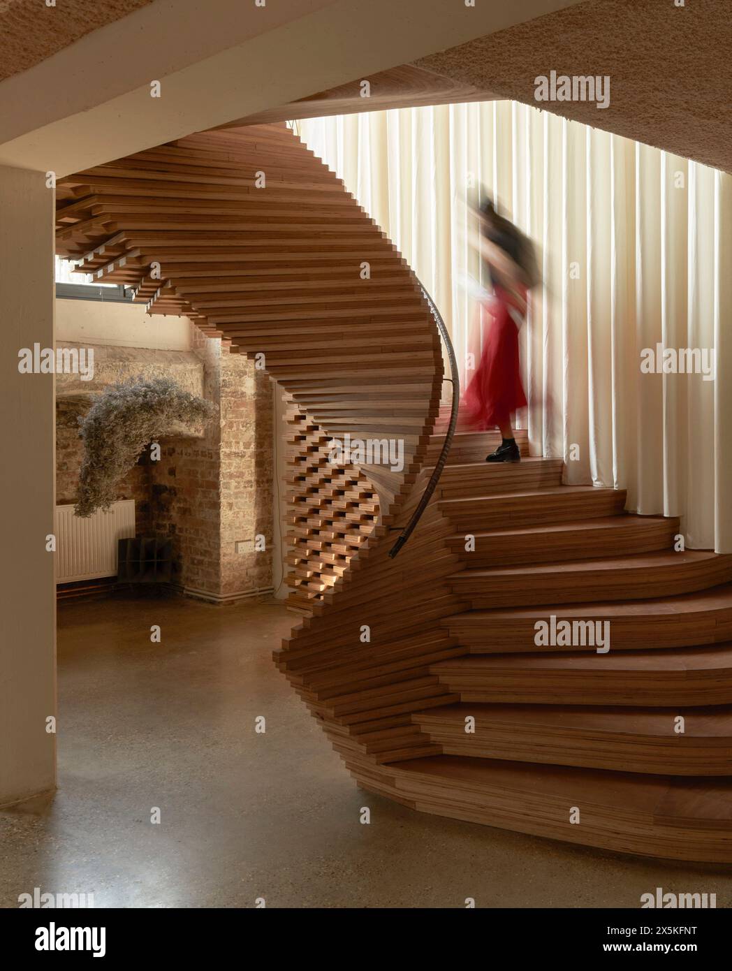 Sculptural curvaceous timber staircase with figure ascending. ACME ...
