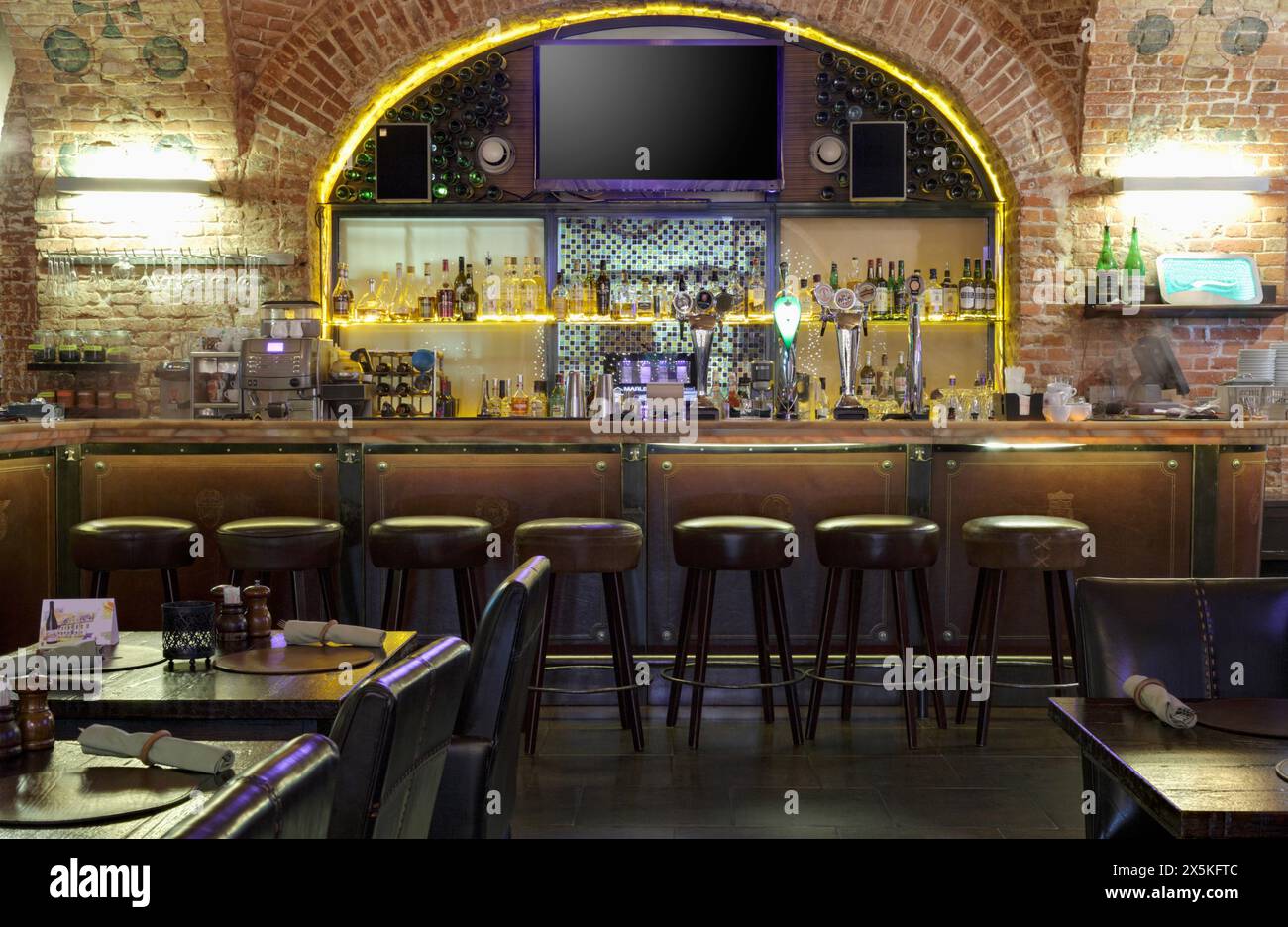 Interior view of bar with big TV screen on wall Stock Photo - Alamy