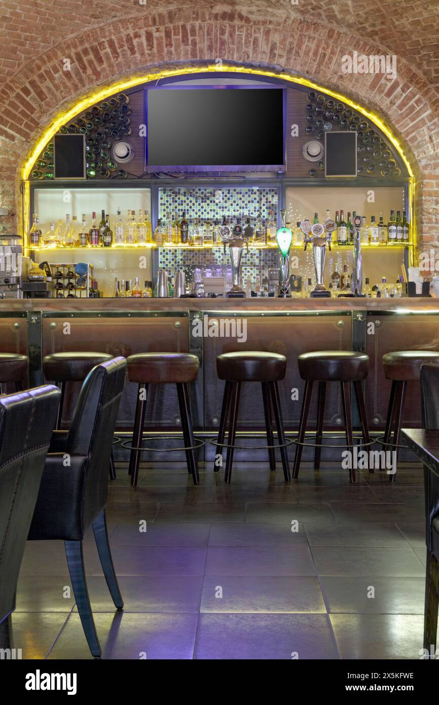Interior view of bar with big TV screen on wall Stock Photo - Alamy