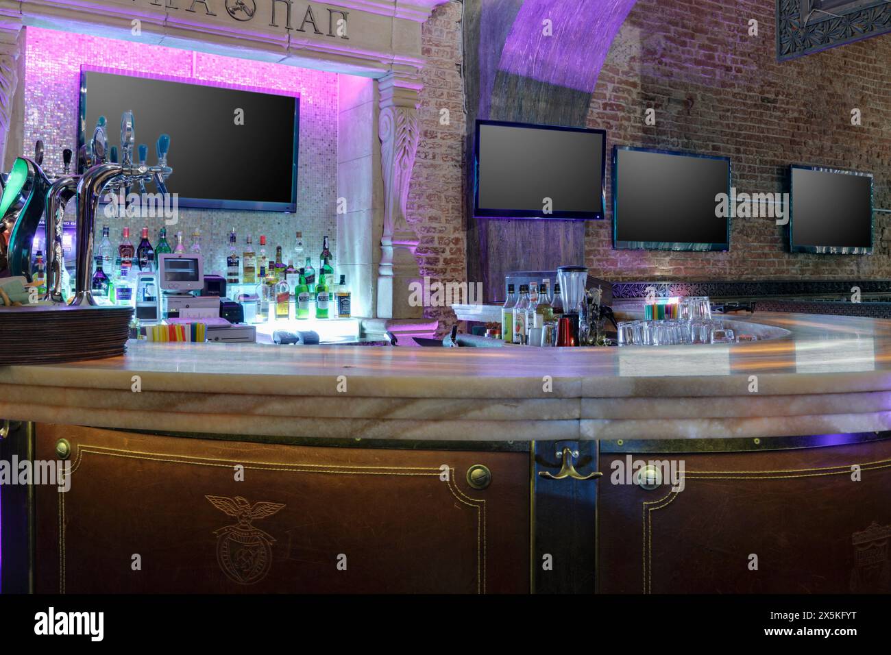 Detail of bar area with TV screens in a restaurant Stock Photo - Alamy