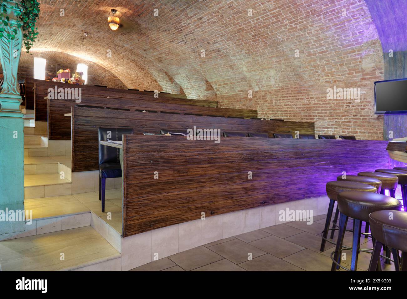 Tiered seats emulating arena in a sports bar Stock Photo - Alamy