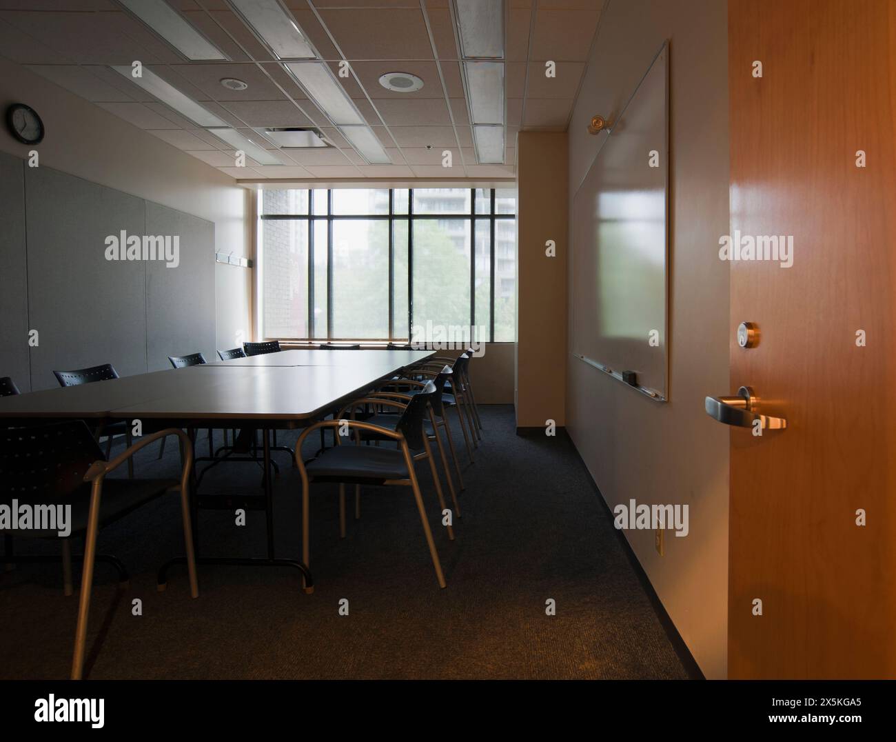 An office interior with door open to empty boardroom Stock Photo - Alamy
