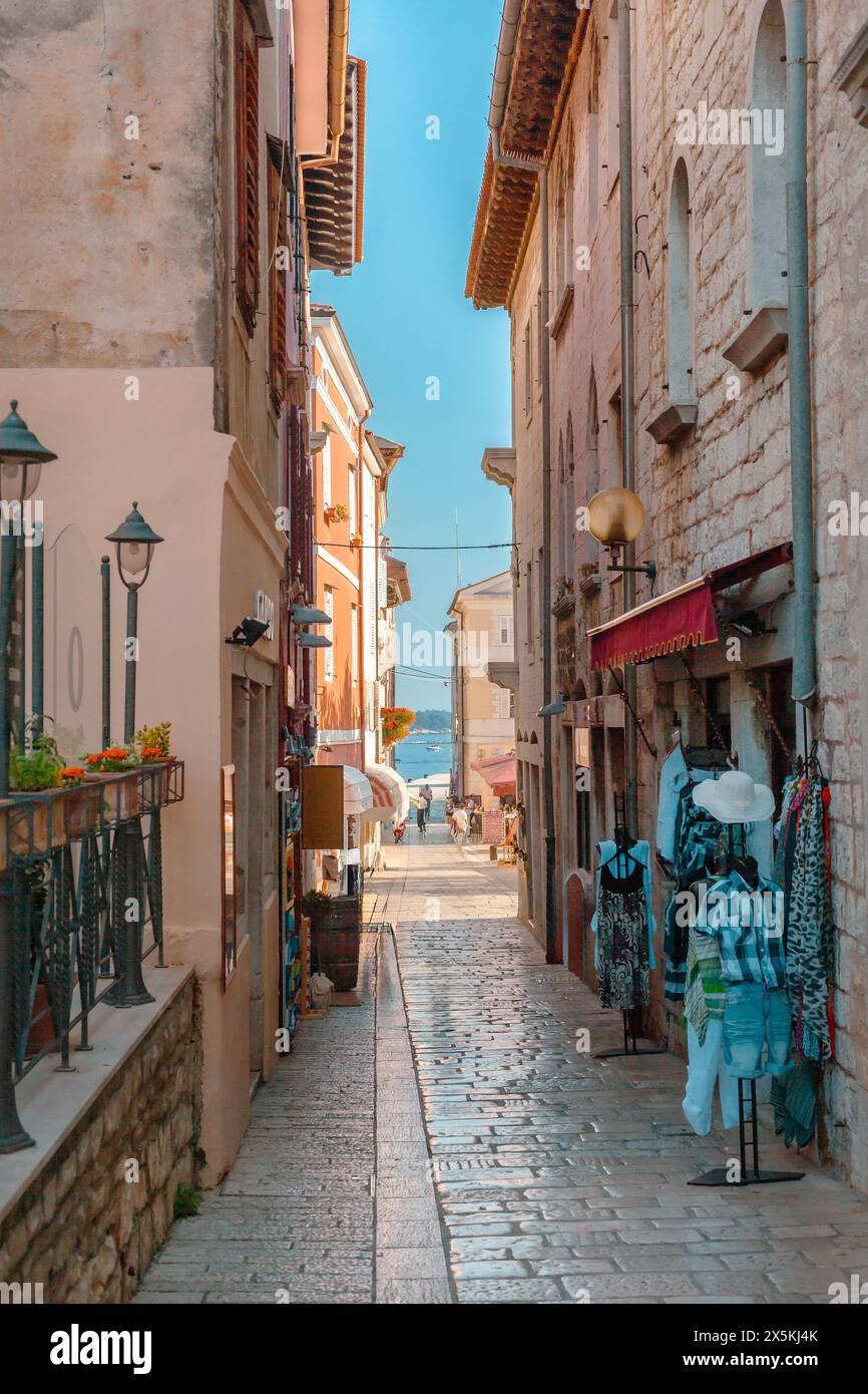 Picturesque Mediterranean street with outdoor cafes and people walking ...