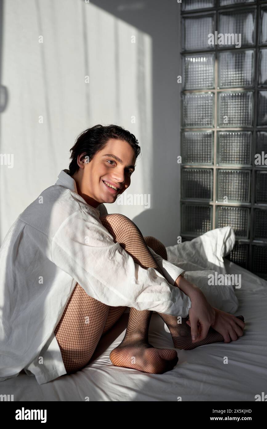 cheerful transgender LGBT looking at camera while posingn the living ...