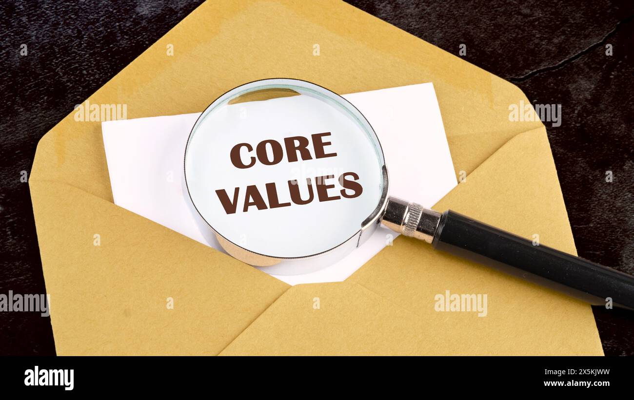CORE VALUES. ethics concept, text on a white sheet of paper through a ...