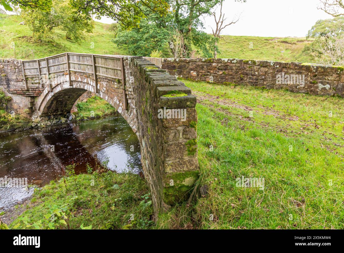 England, Penrith, Shap Rural. Grass-covered, stone bridge over River ...