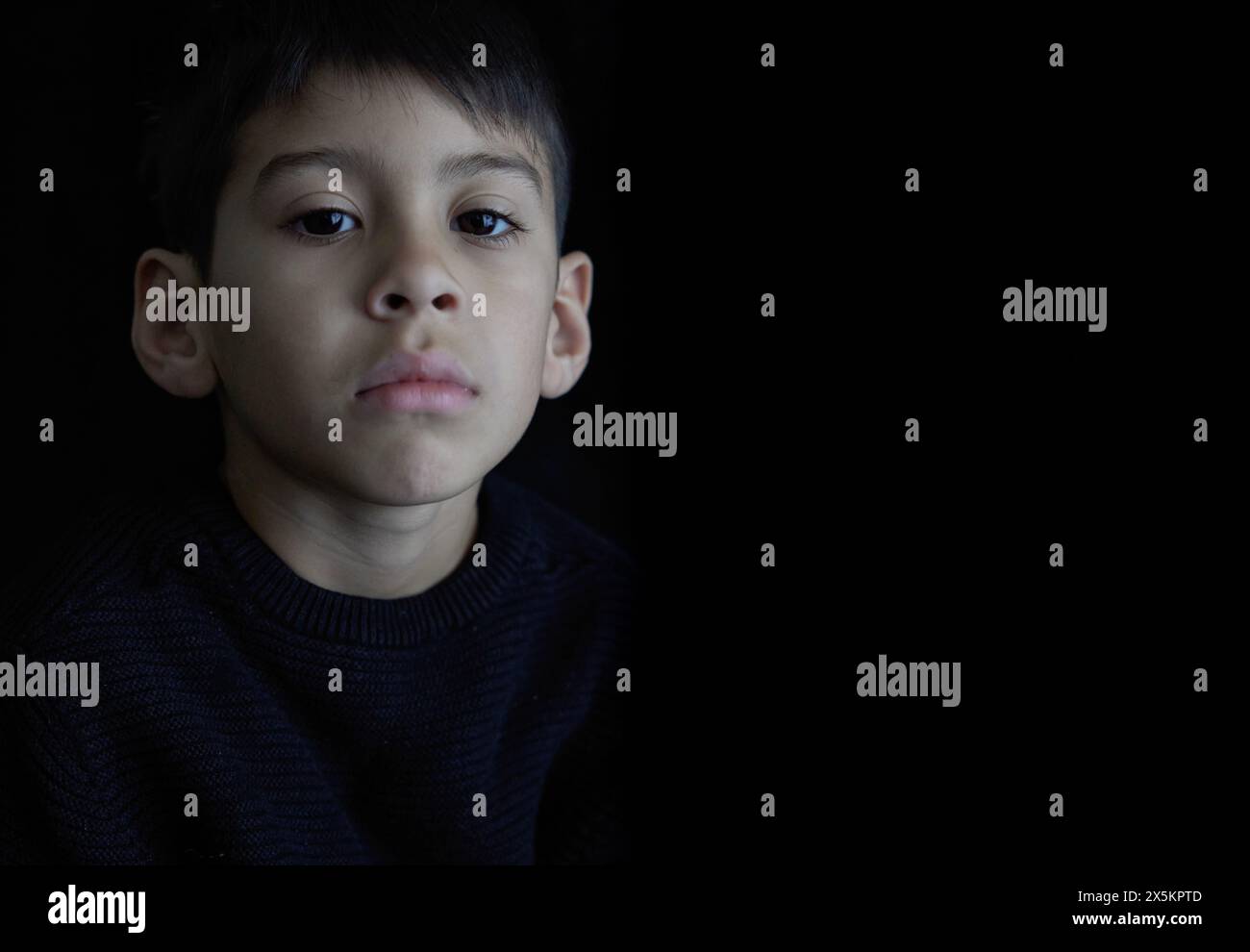 close-up portrait of face of Latino boy facing front looking at camera ...