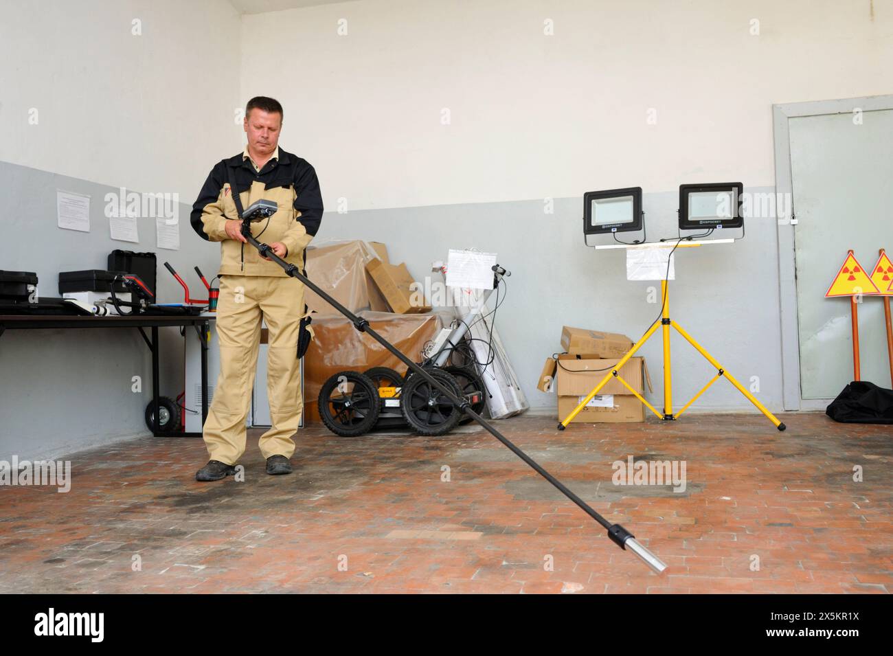 Radiation detector testing. Dosimetrist adjusting a portable gamma ...