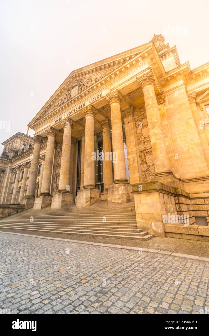 The Reichstag Building bathes in the warm glow of the setting sun ...