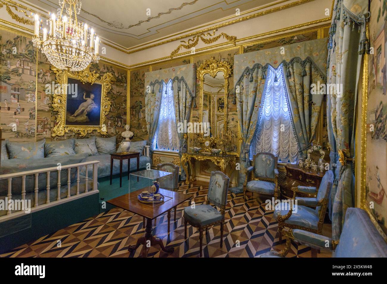 A state bedroom in the Peterhof palace with a bed and sofas, windows ...