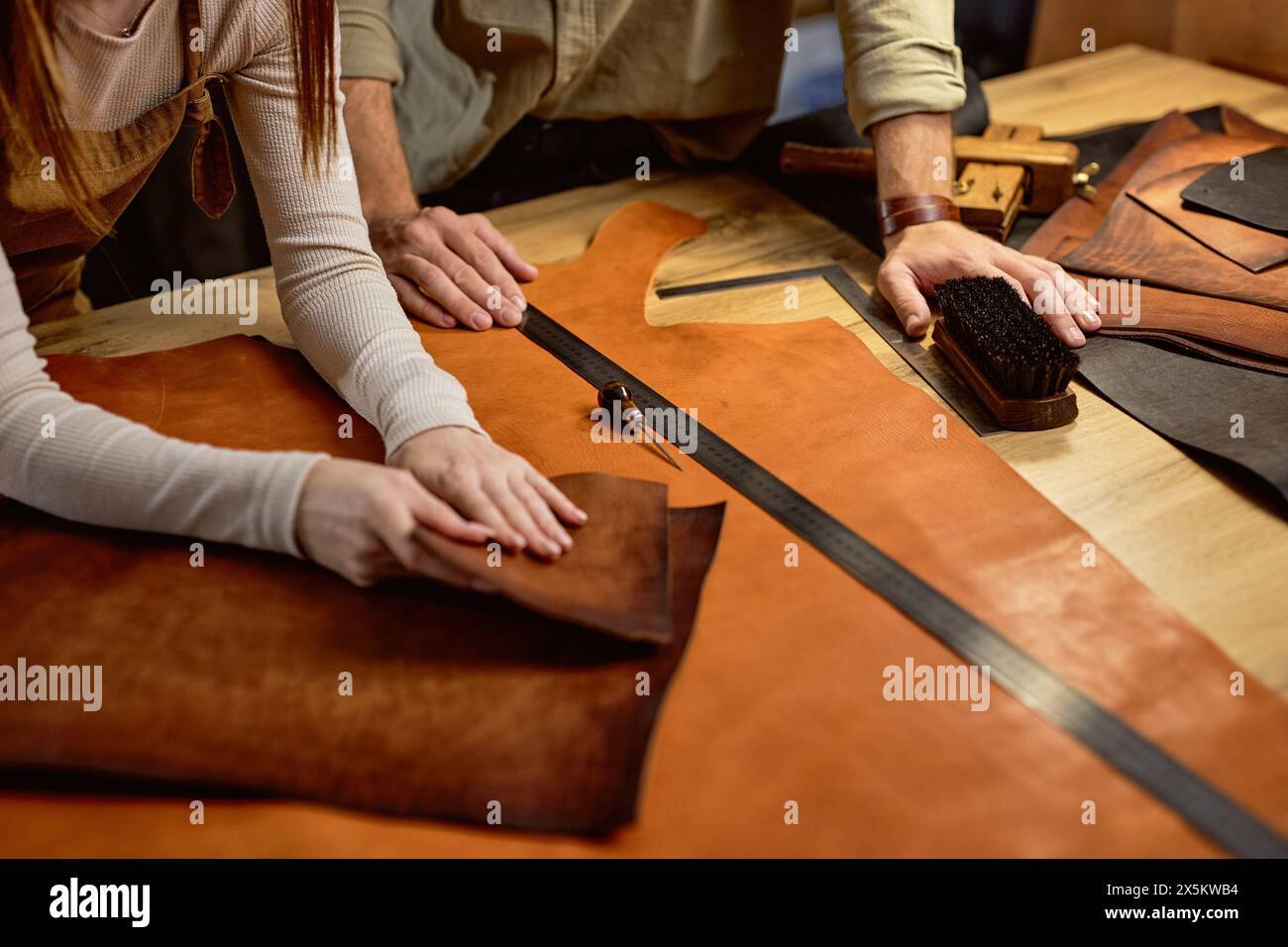 Working process in the leather workshop. people's hands holding ...