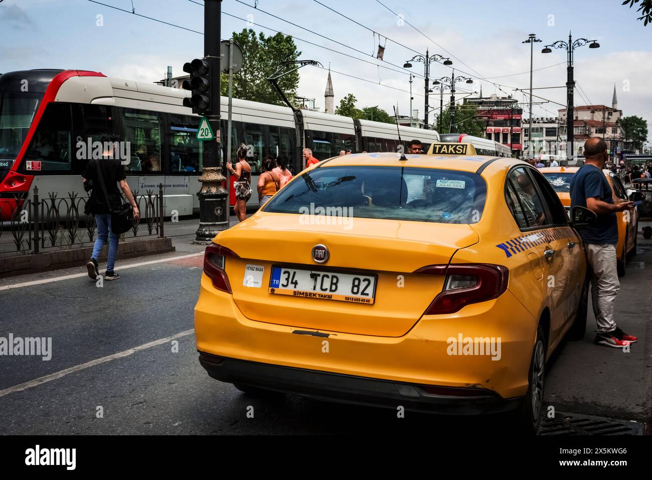 a taxi, parked in the busy streets of Istanbul, awaits the arrival of ...