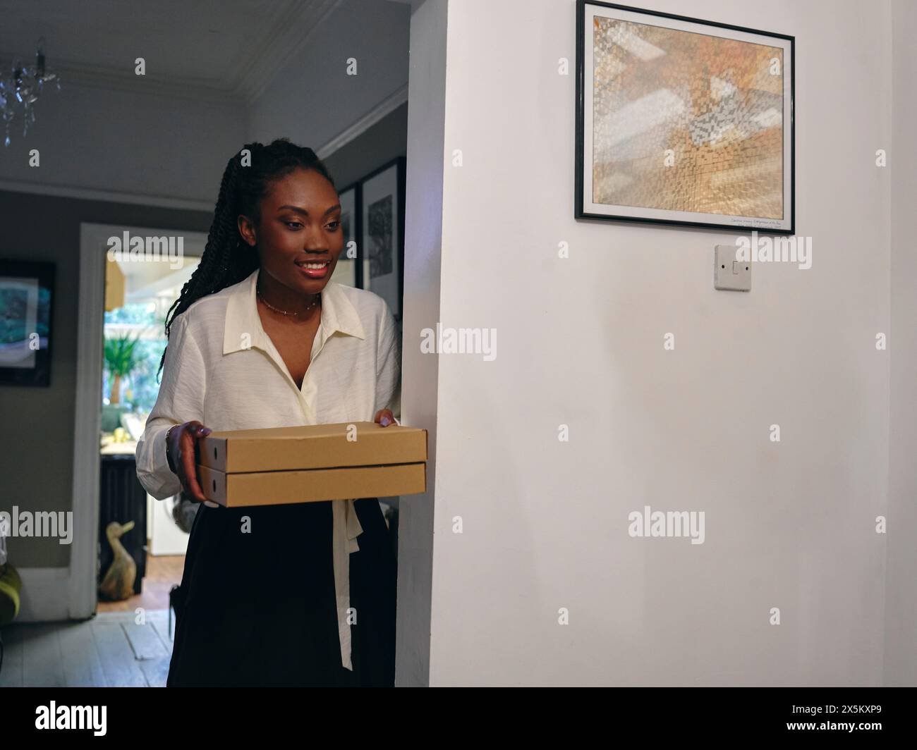 African woman holding pizza boxes hi-res stock photography and images ...