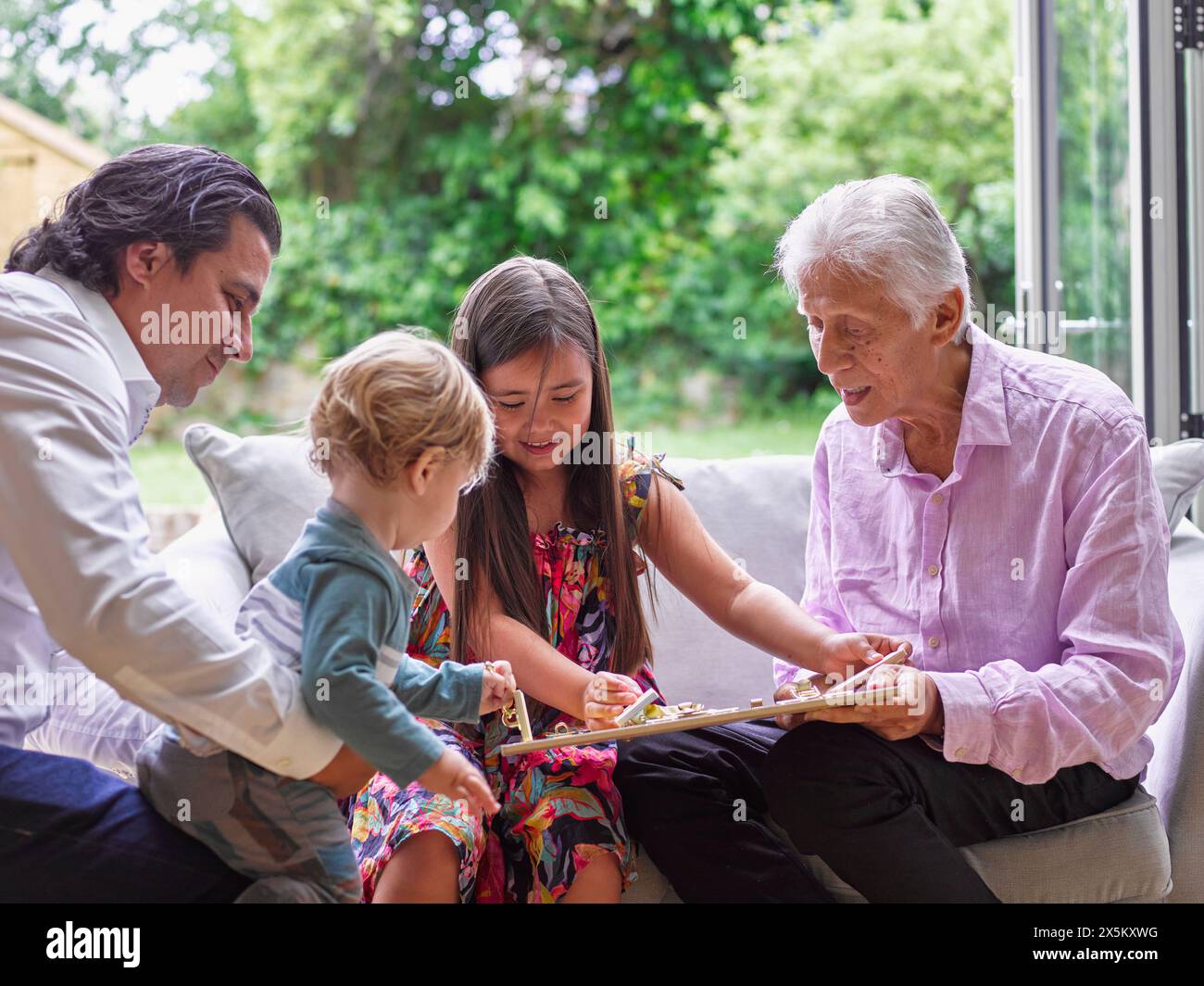 Multi generational family playing at home Stock Photo - Alamy