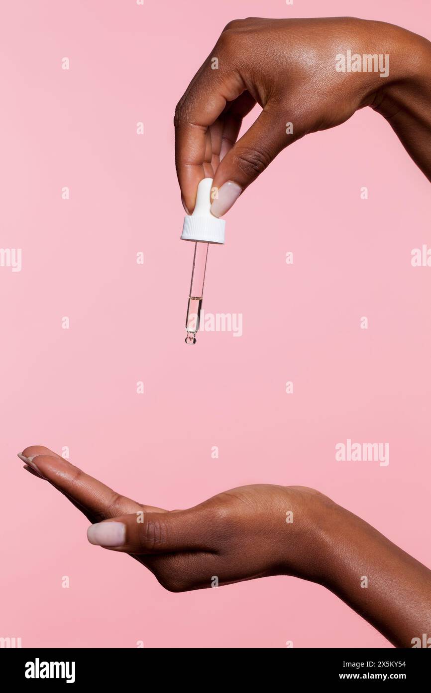 Female hands holding serum pipette Stock Photo - Alamy