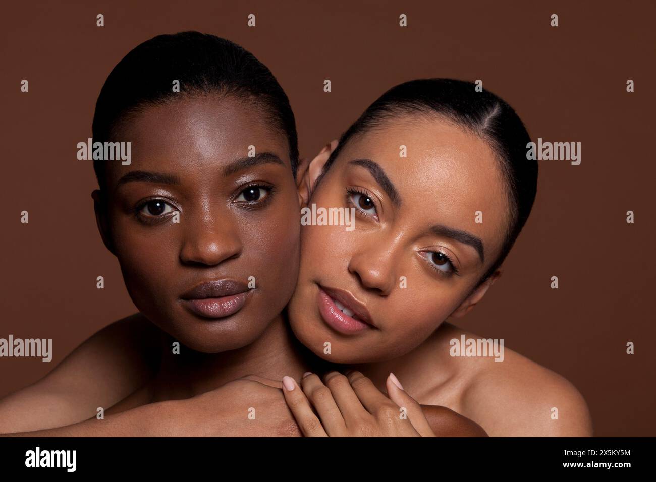 Portrait of young women embracing Stock Photo - Alamy