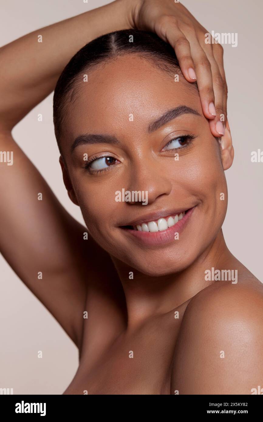 Smile woman hand on head hi-res stock photography and images - Alamy