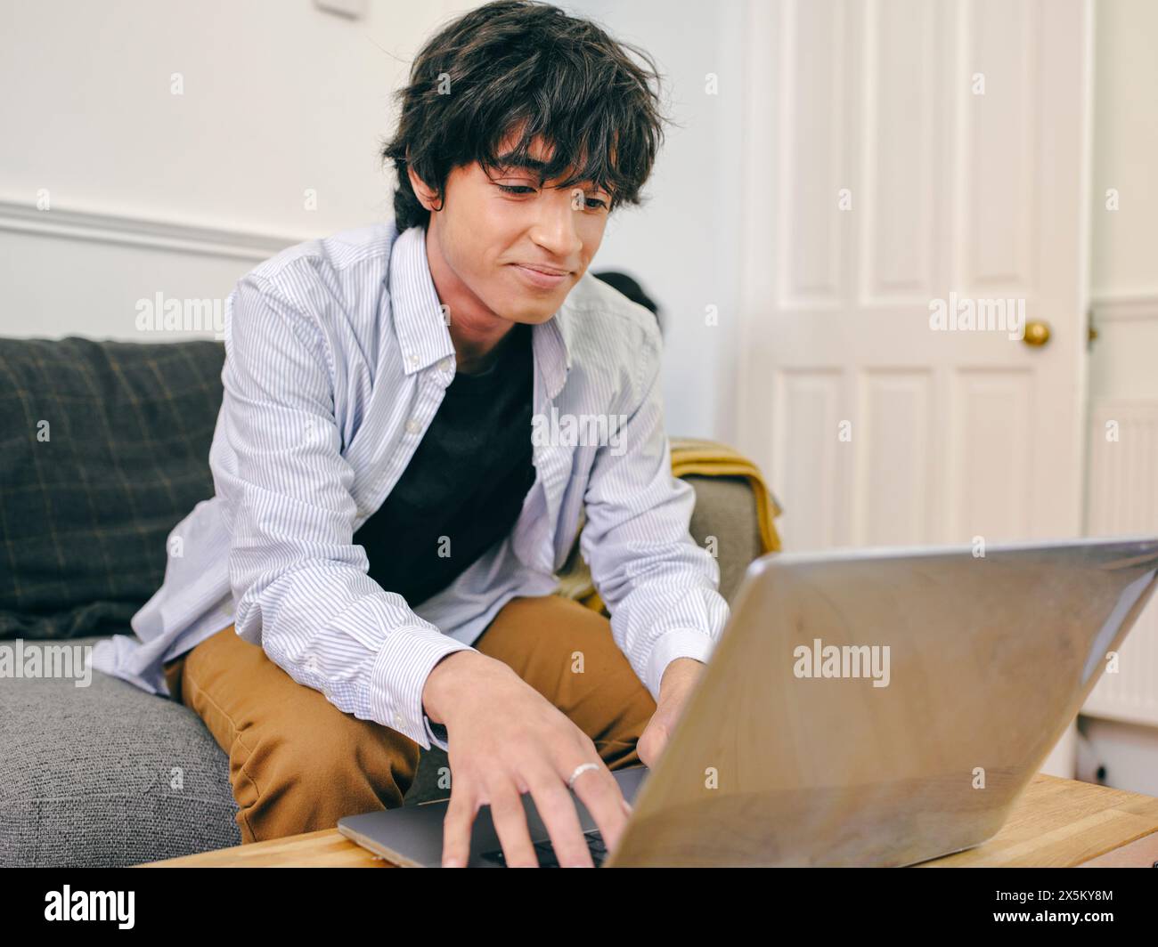 Teenage boy using laptop Stock Photo - Alamy