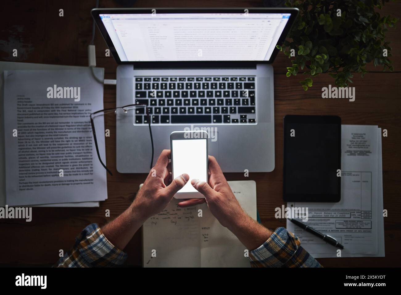 Person, programming and laptop with phone in office with typing for ...