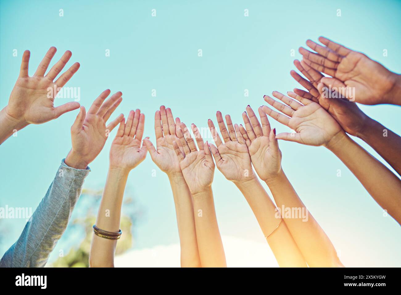 Group of people, blue sky and hands on air for teamwork, partnership ...