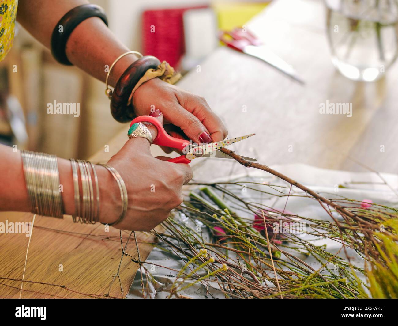 Woman cutting floral decorations with scissors Stock Photo - Alamy