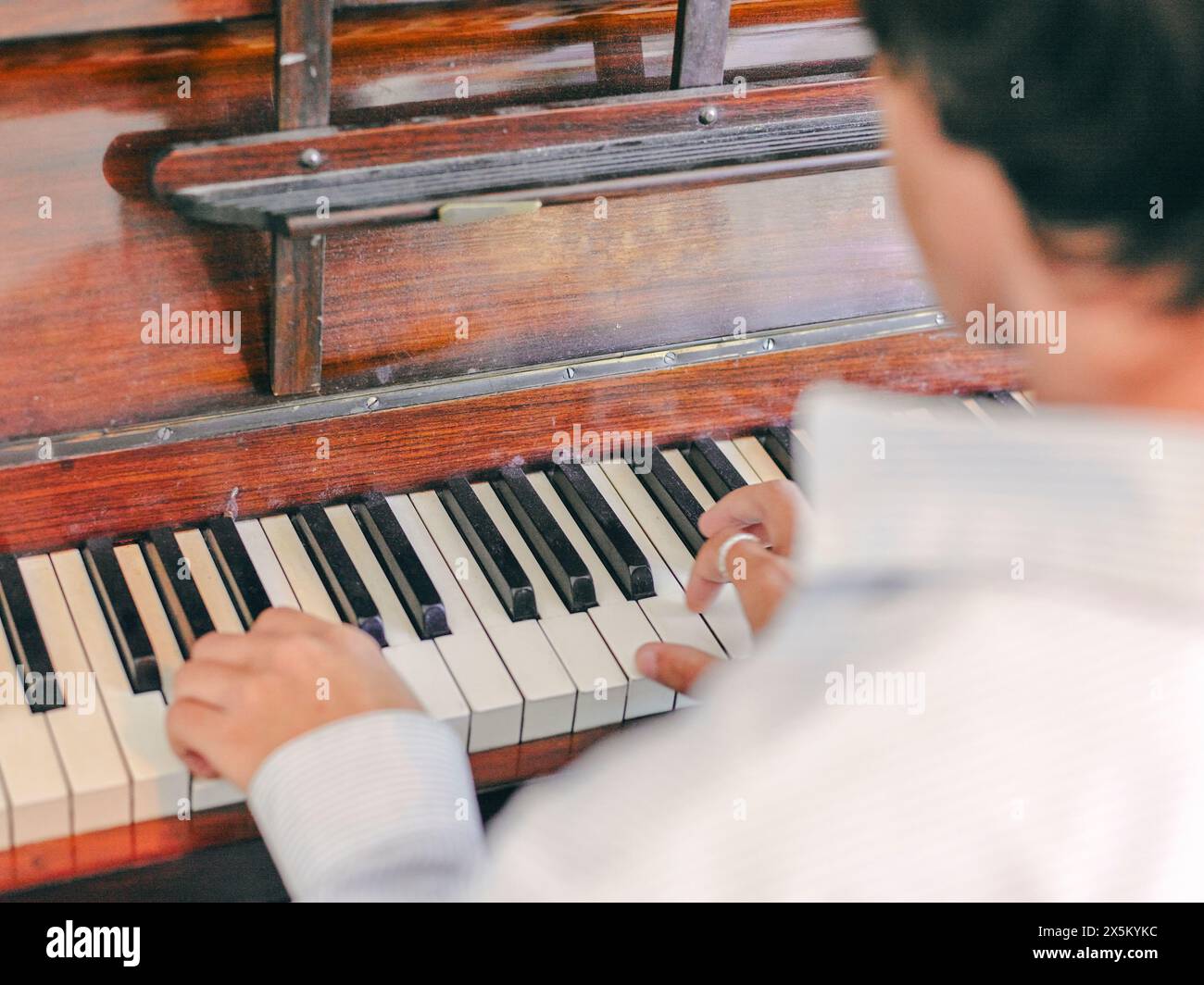 Boy playing piano Stock Photo - Alamy