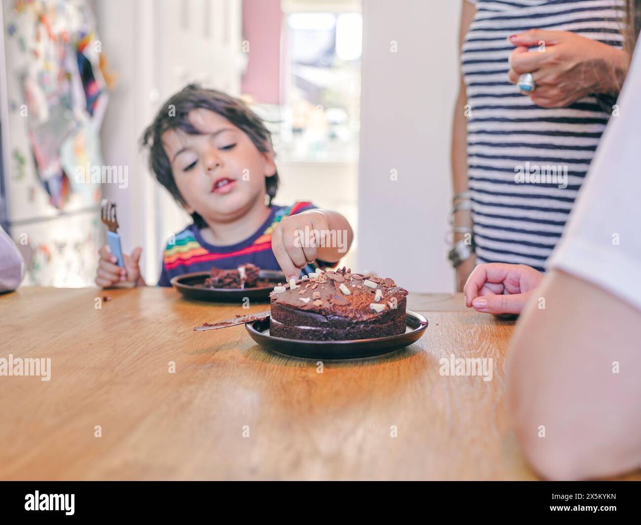 Family eating birthday cake Stock Photo - Alamy