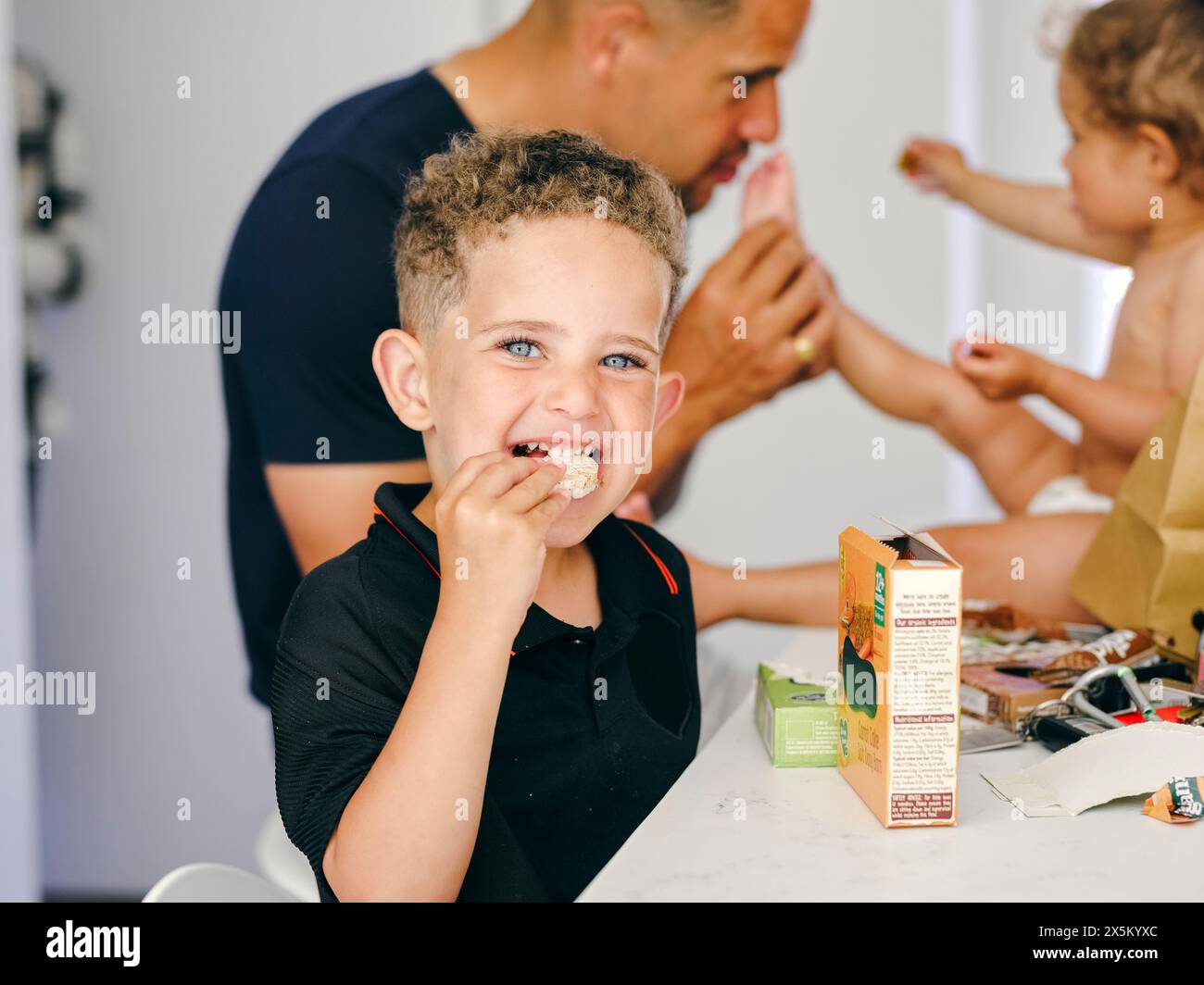 Boy with sister and father at home Stock Photo - Alamy