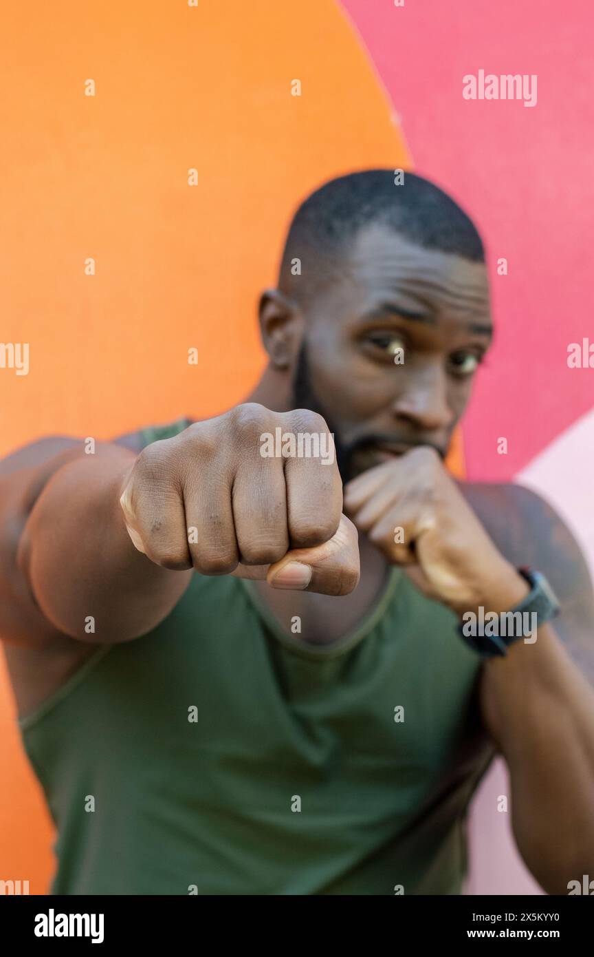 Portrait of mid adult man clenching fists Stock Photo - Alamy