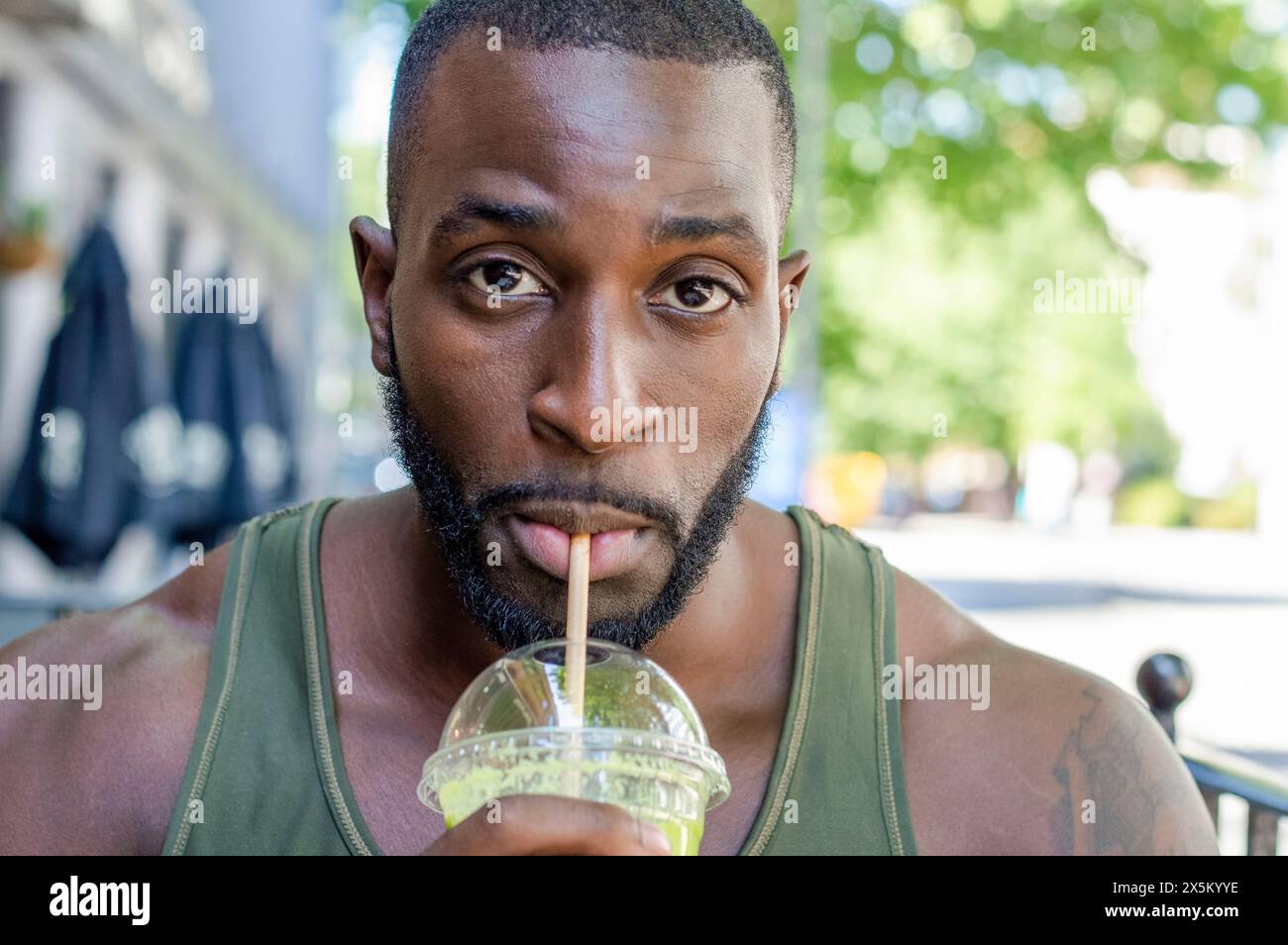 Mid adult man drinking smoothie Stock Photo - Alamy