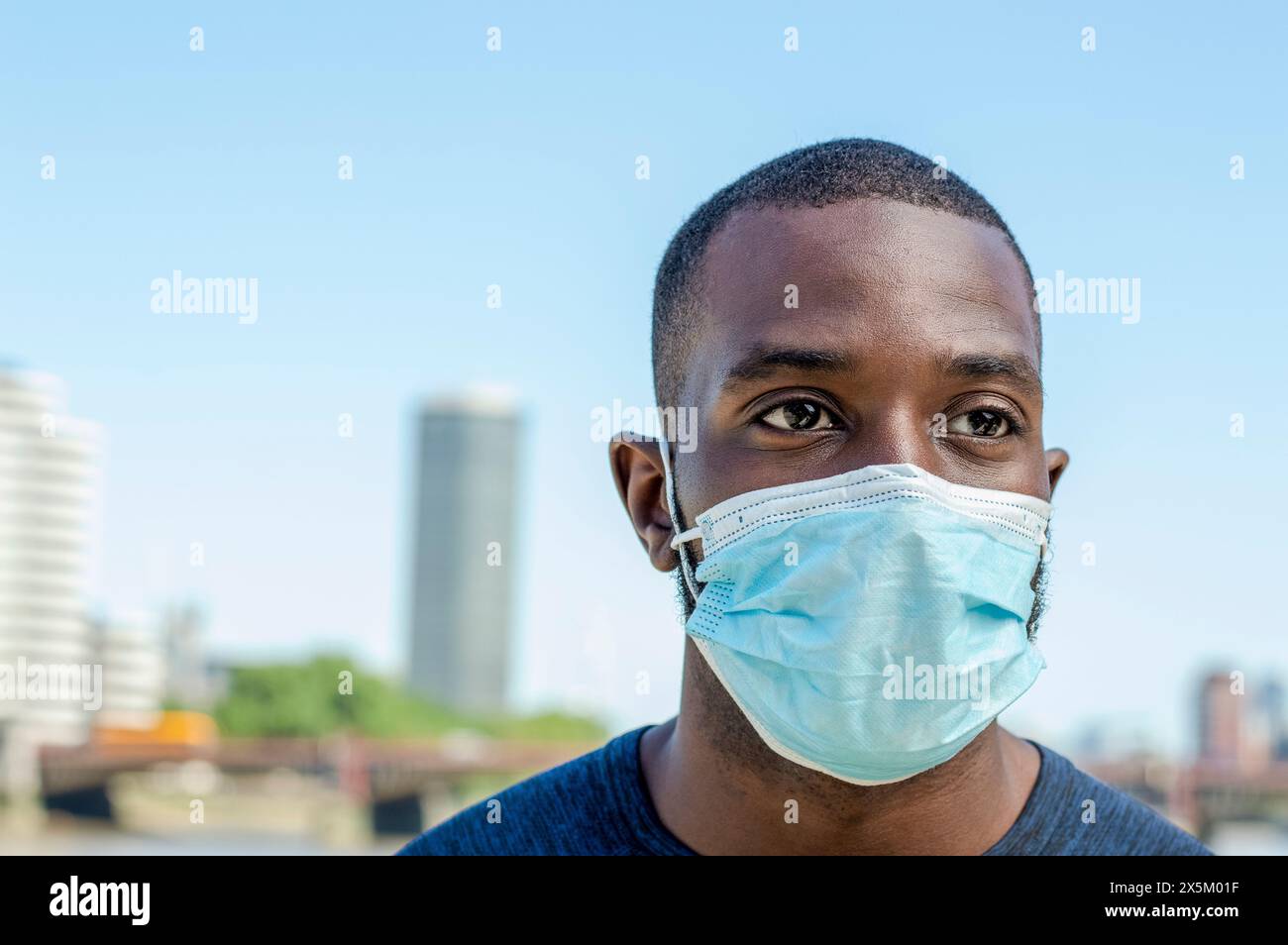 Mid adult man wearing protective face mask Stock Photo - Alamy