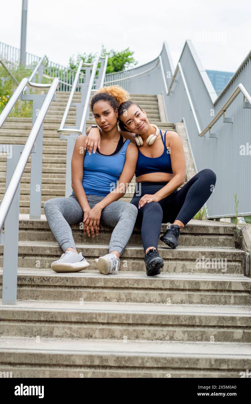 Two people sitting on stairs hi-res stock photography and images - Alamy