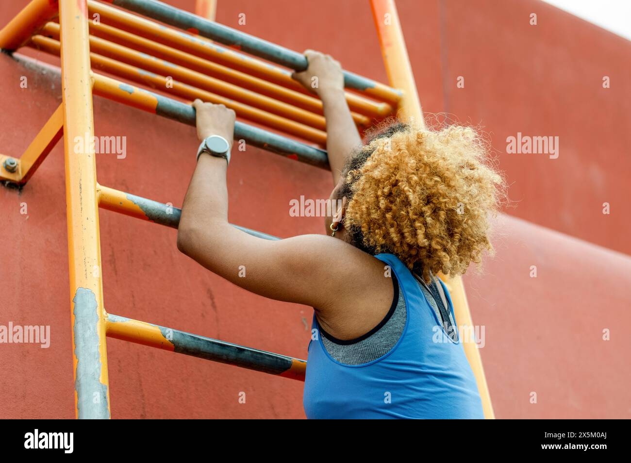 Woman climbing ladder hi-res stock photography and images - Alamy