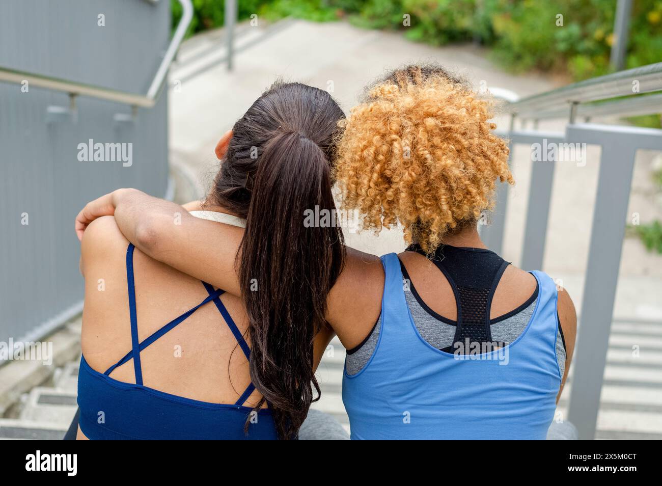 Female friends embracing Stock Photo - Alamy
