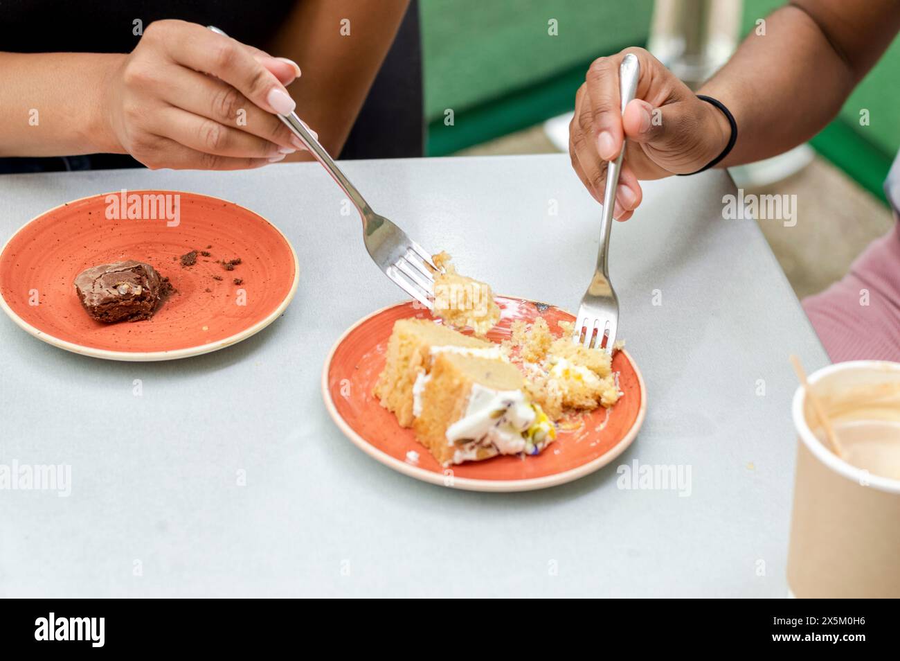 Two women eating cake hi-res stock photography and images - Alamy