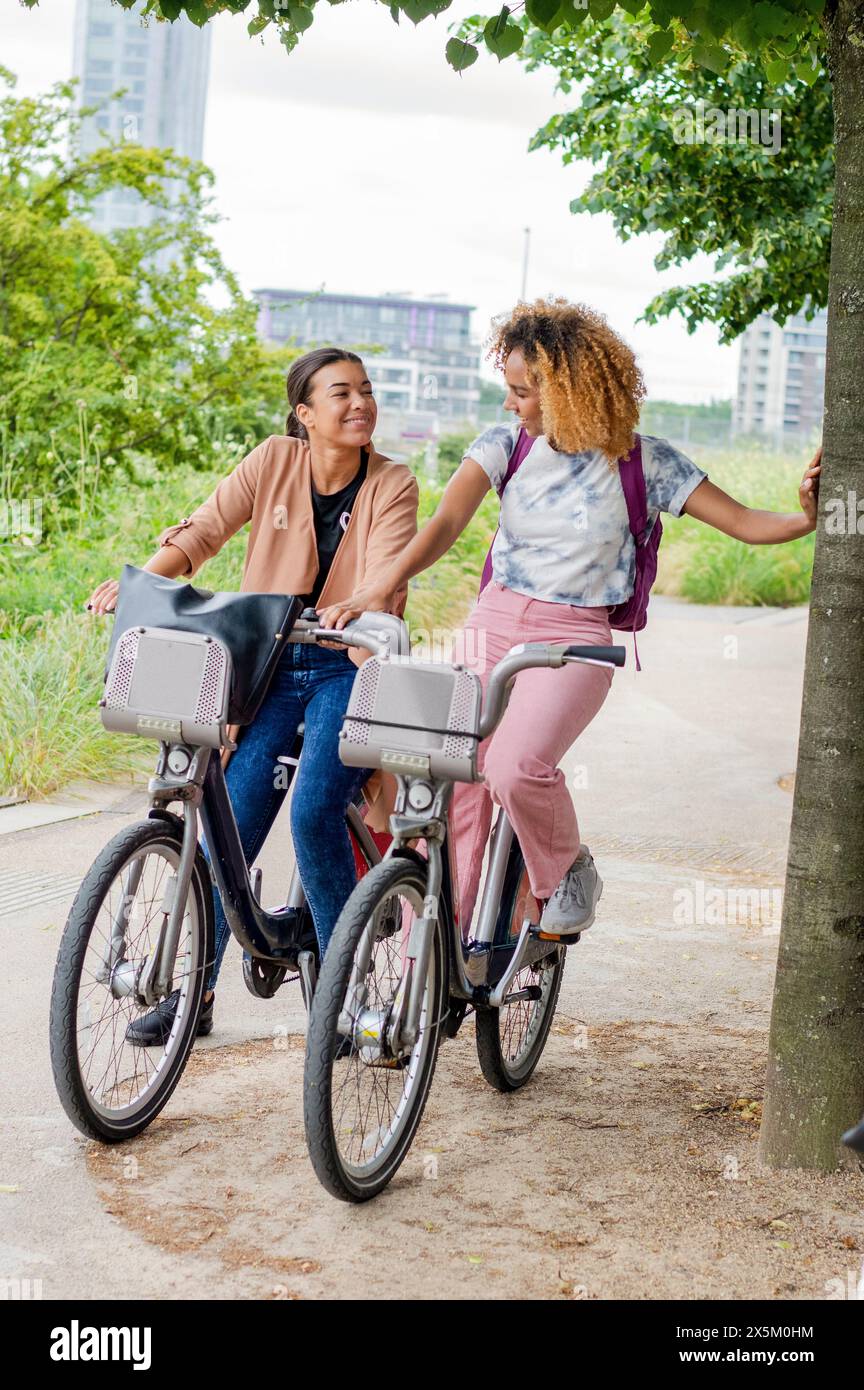 Two women on bicycles Stock Photo - Alamy