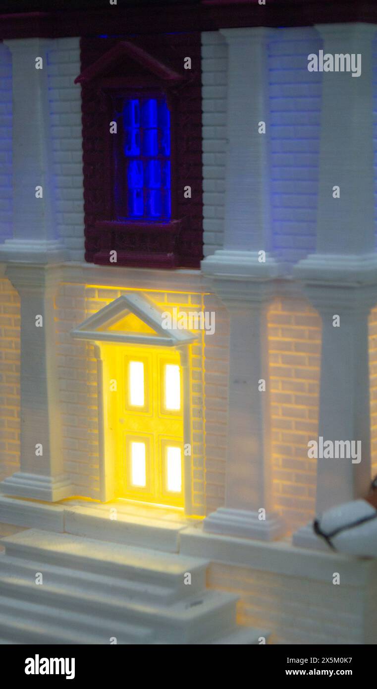 Prototype printed on 3D printer brick building with columns and glowing ...