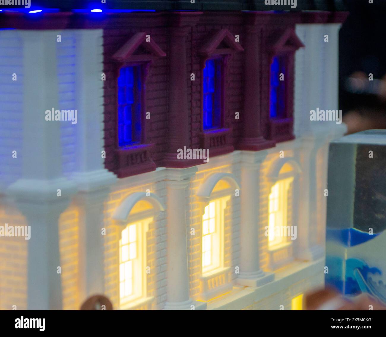 Prototype printed on 3D printer brick building with columns and glowing ...