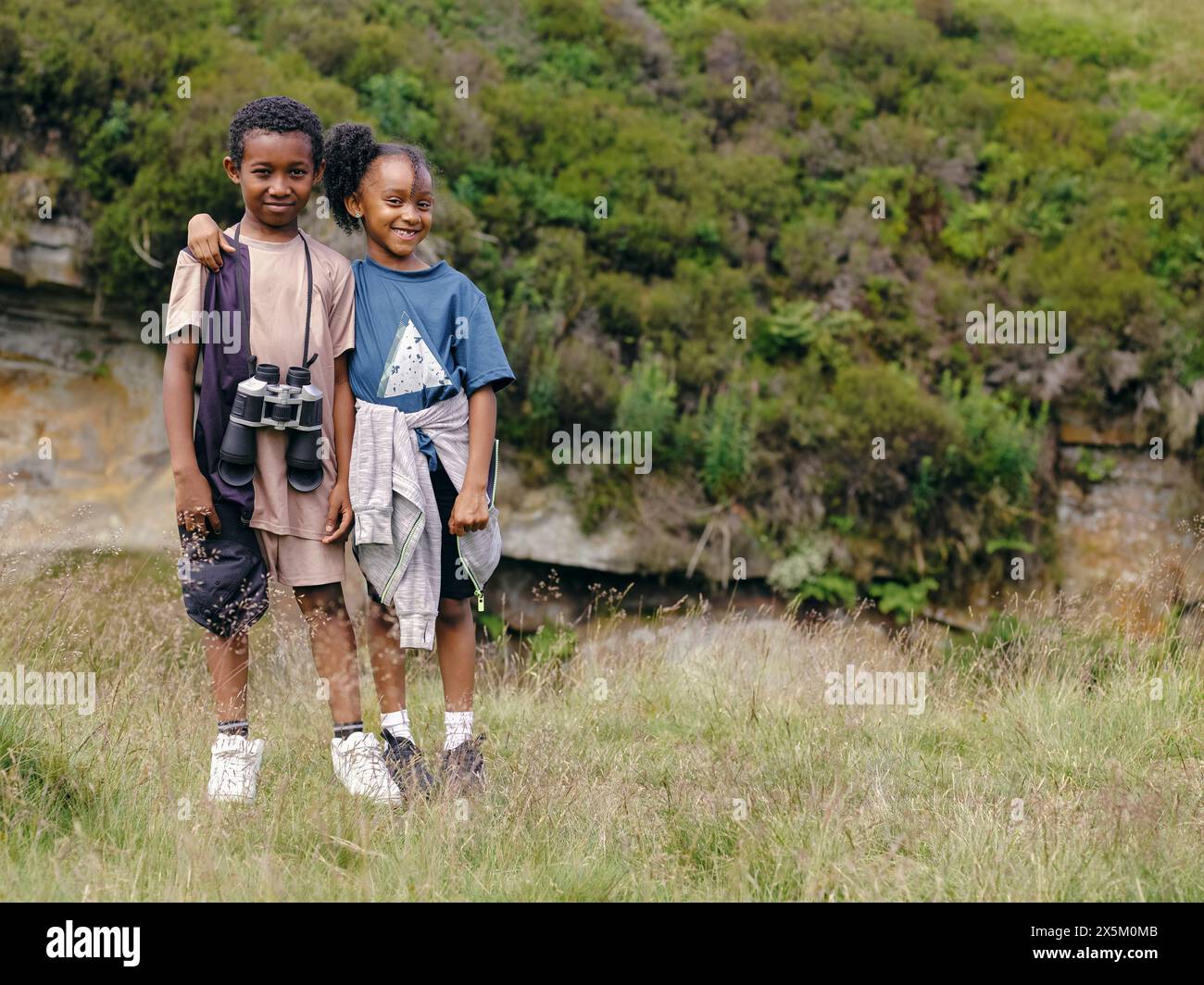Outdoor portrait of brother and sister embracing in nature Stock Photo ...