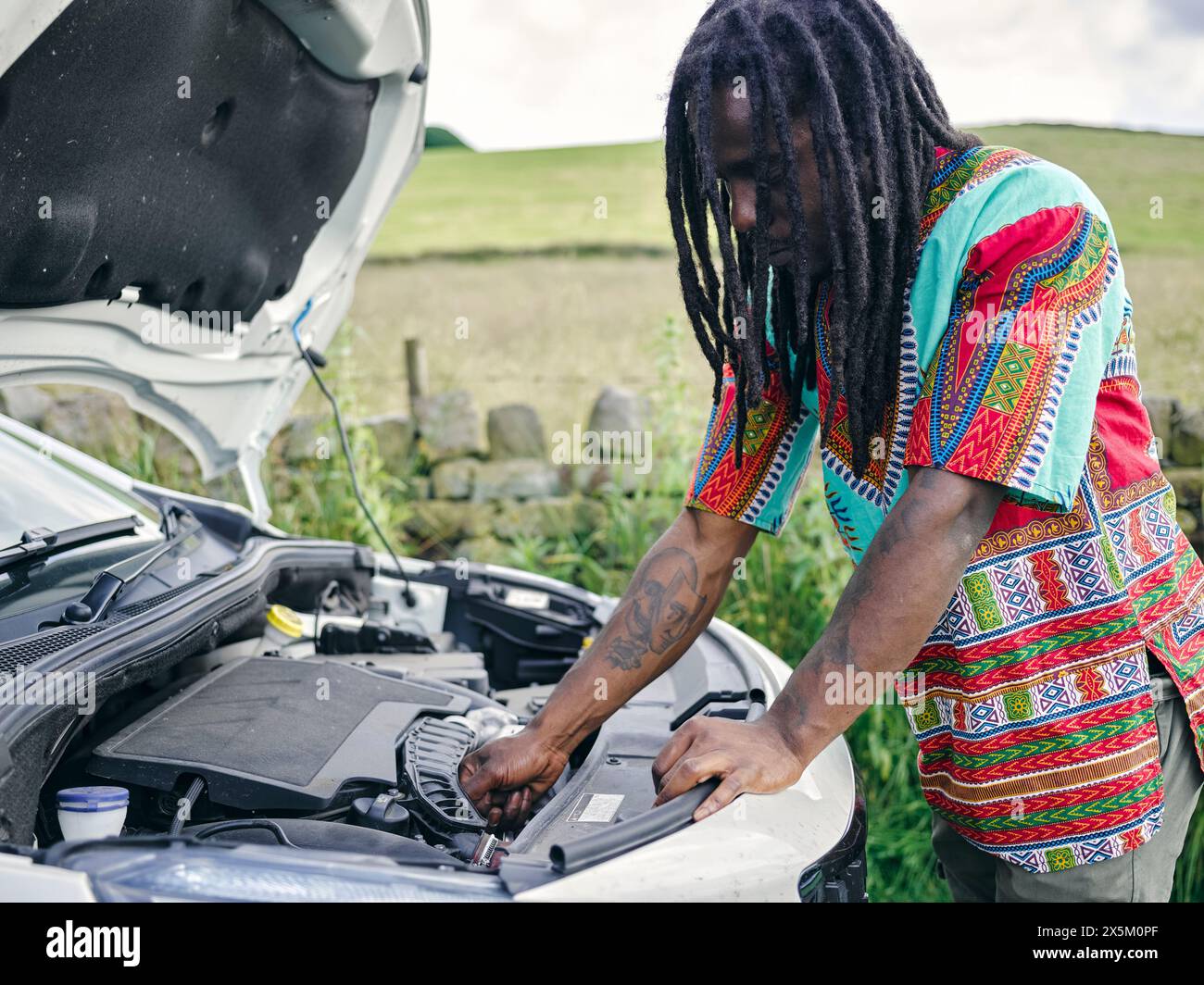 Man fixing car on roadside Stock Photo - Alamy