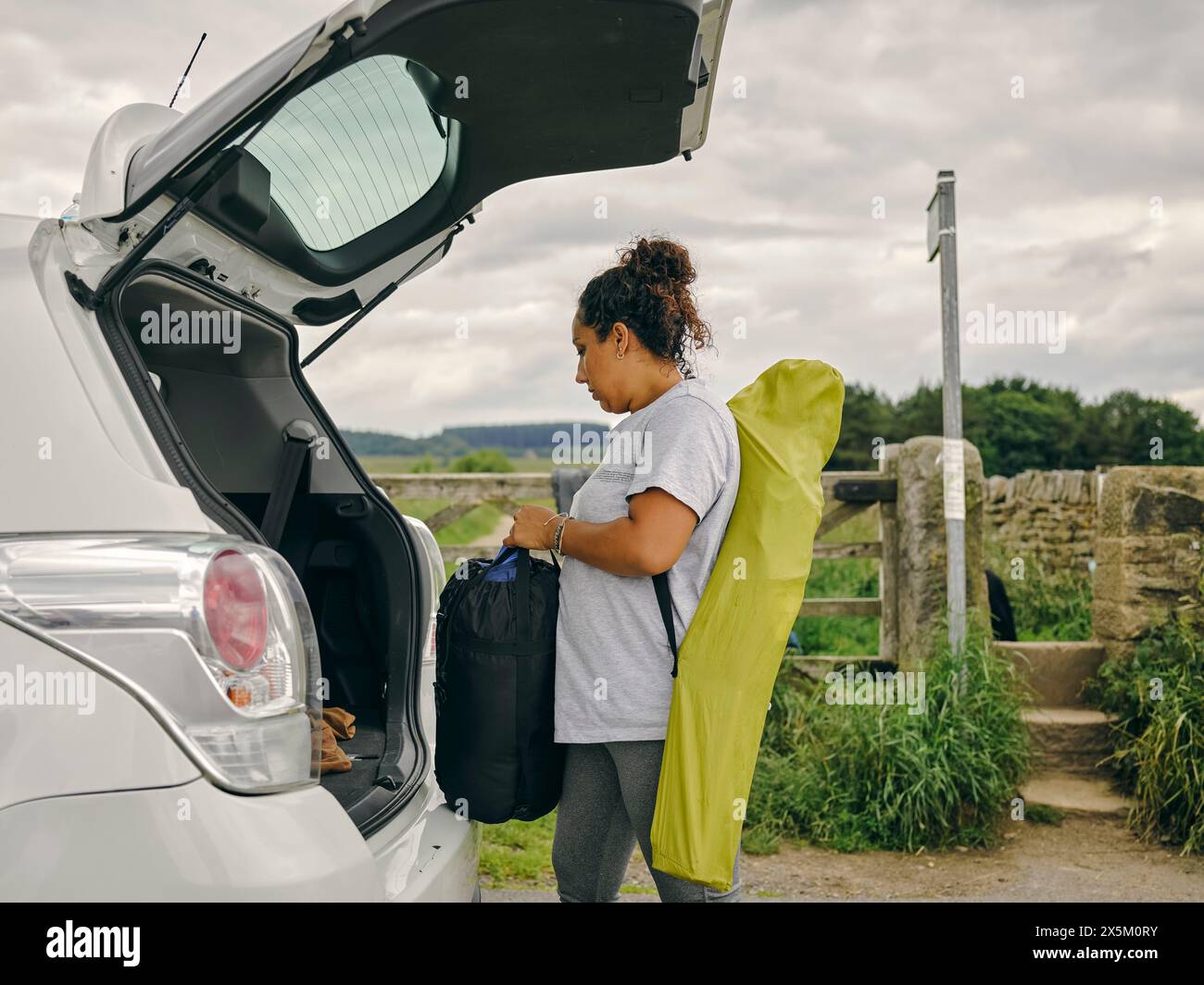 Woman loading car trunk hi-res stock photography and images - Alamy
